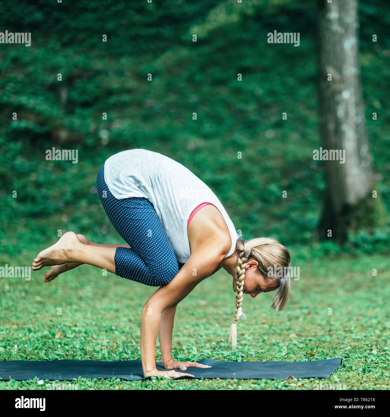 Yoga crow position Stock Photo - Alamy
