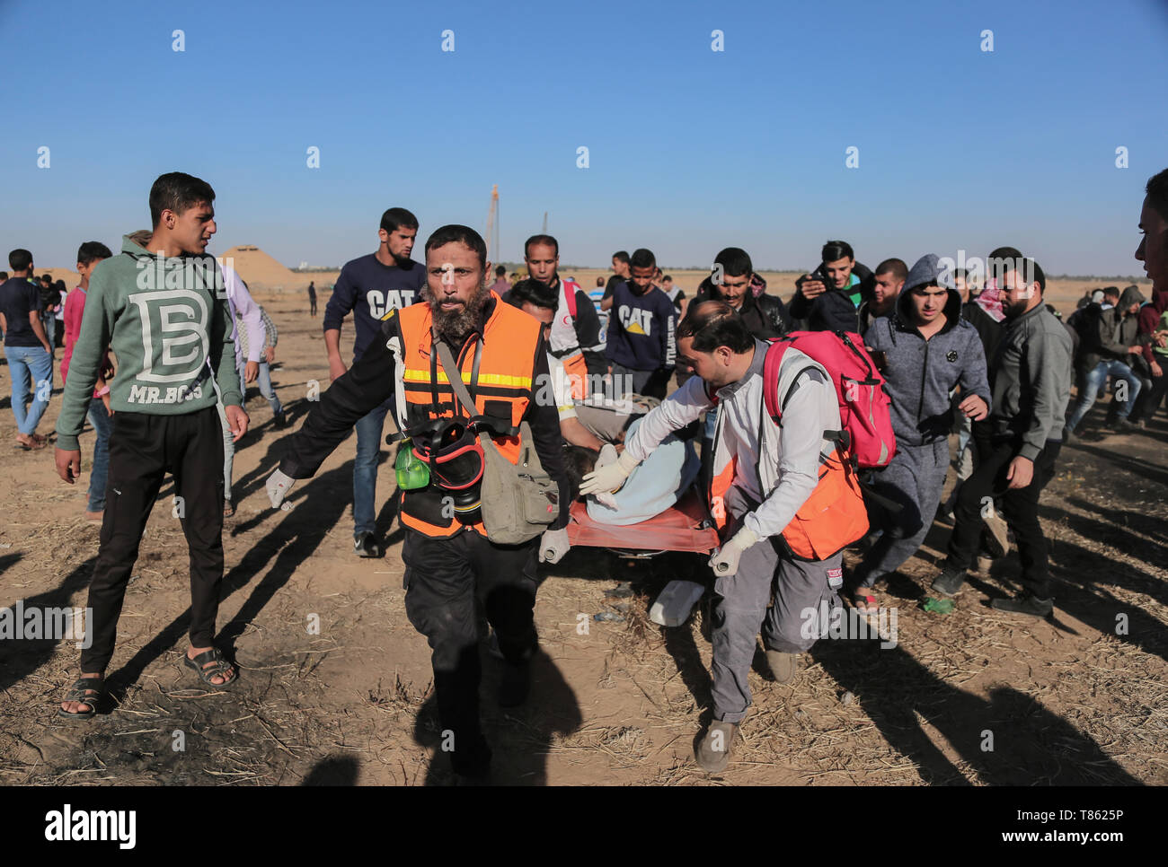 Palestinian medics are seen carrying an injured person during the ...