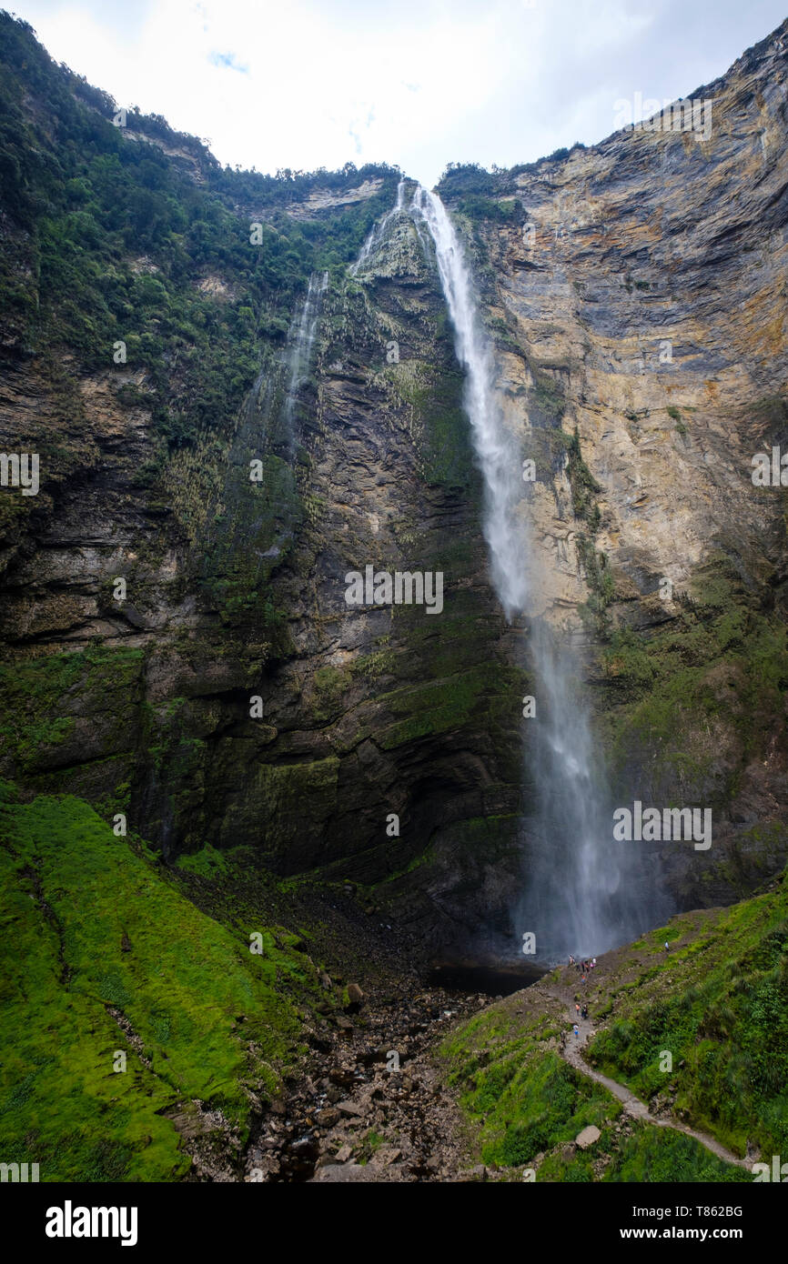 People seen small at the base of Gocta Waterfall that is a stunning ...