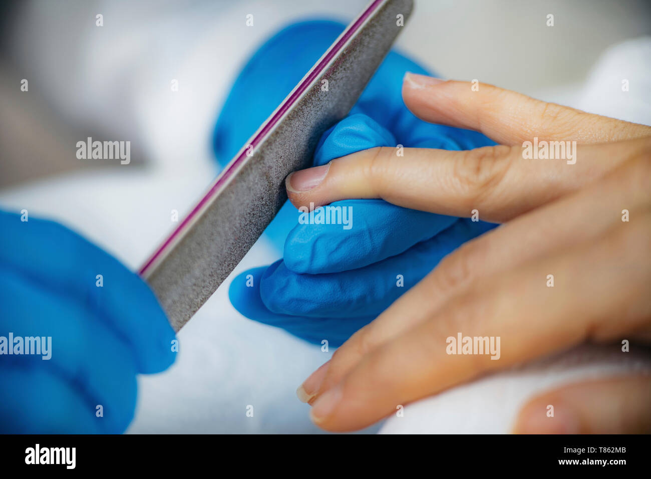Female hands filing nails hi-res stock photography and images - Alamy