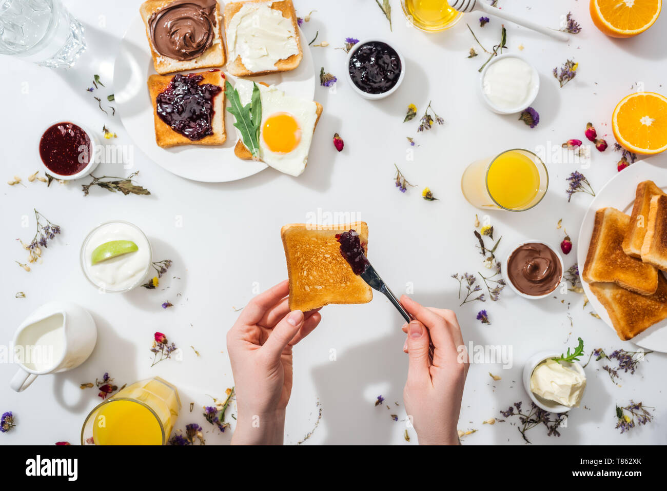 Person spreading honey on bread hi-res stock photography and images - Alamy