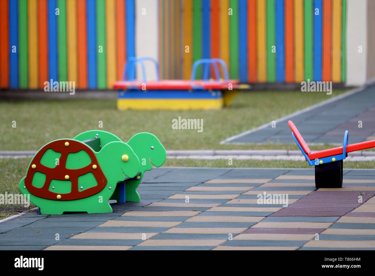 Bright colorful funny bench on nursery playground with soft rubber ...