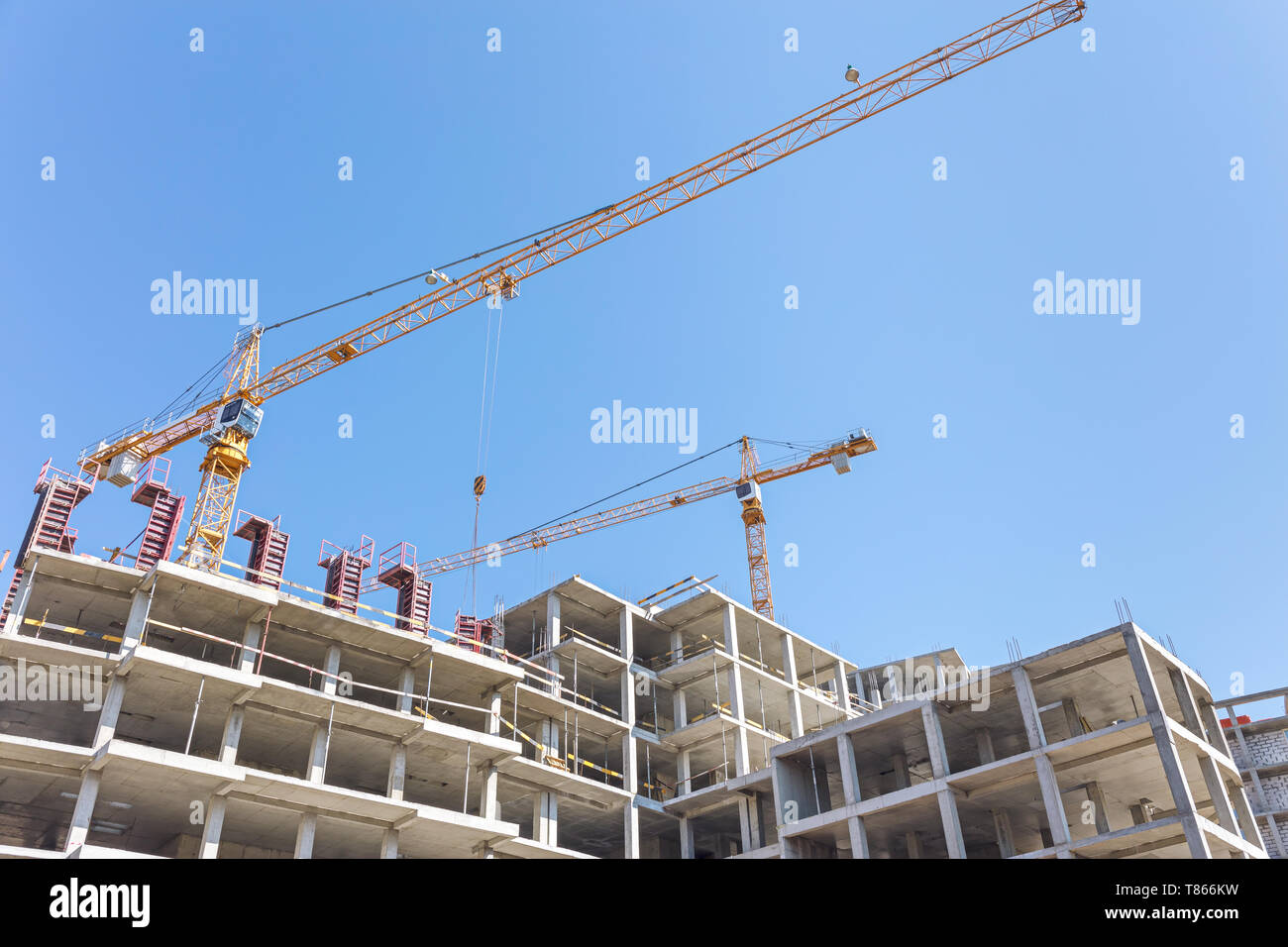 development of new city area. buildings under construction. two cranes ...