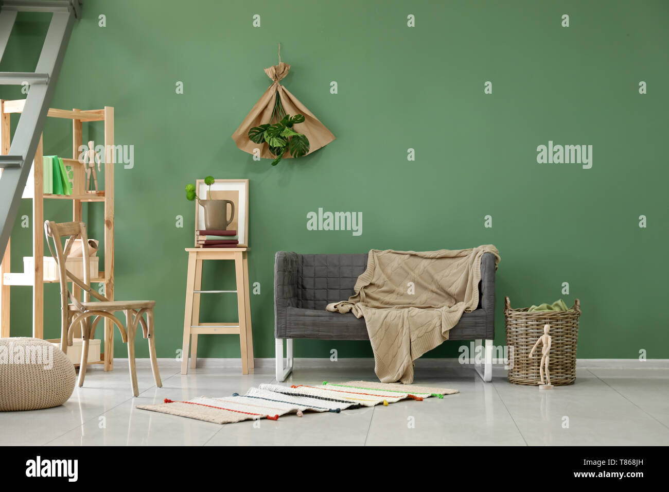 Interior of living room with comfortable sofa near color wall Stock ...