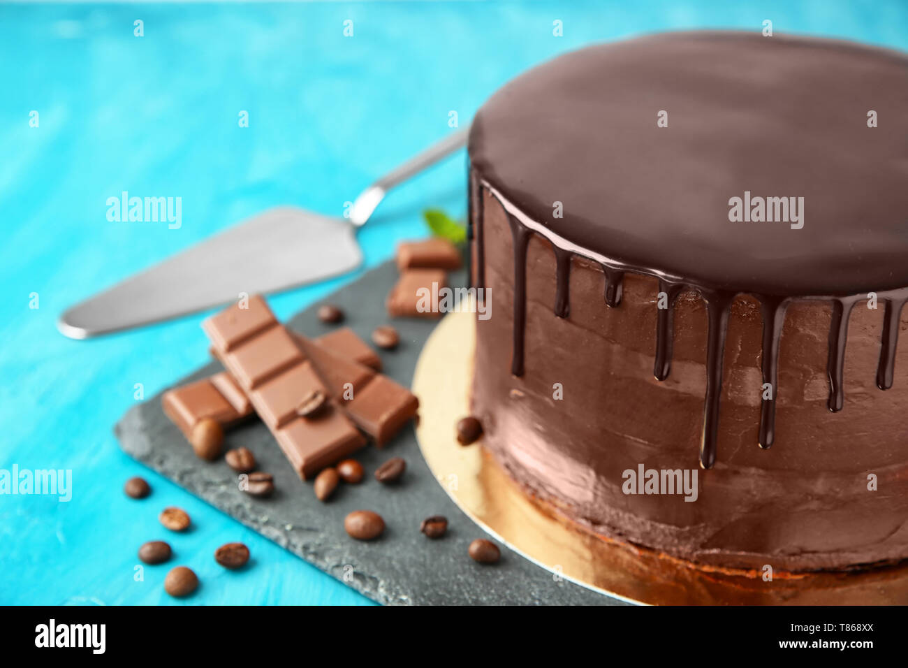Slate plate with delicious chocolate cake on color background, closeup ...