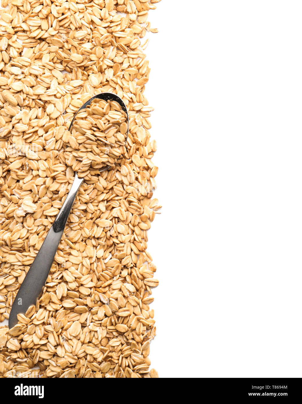 Spoon and raw oatmeal on white background Stock Photo - Alamy
