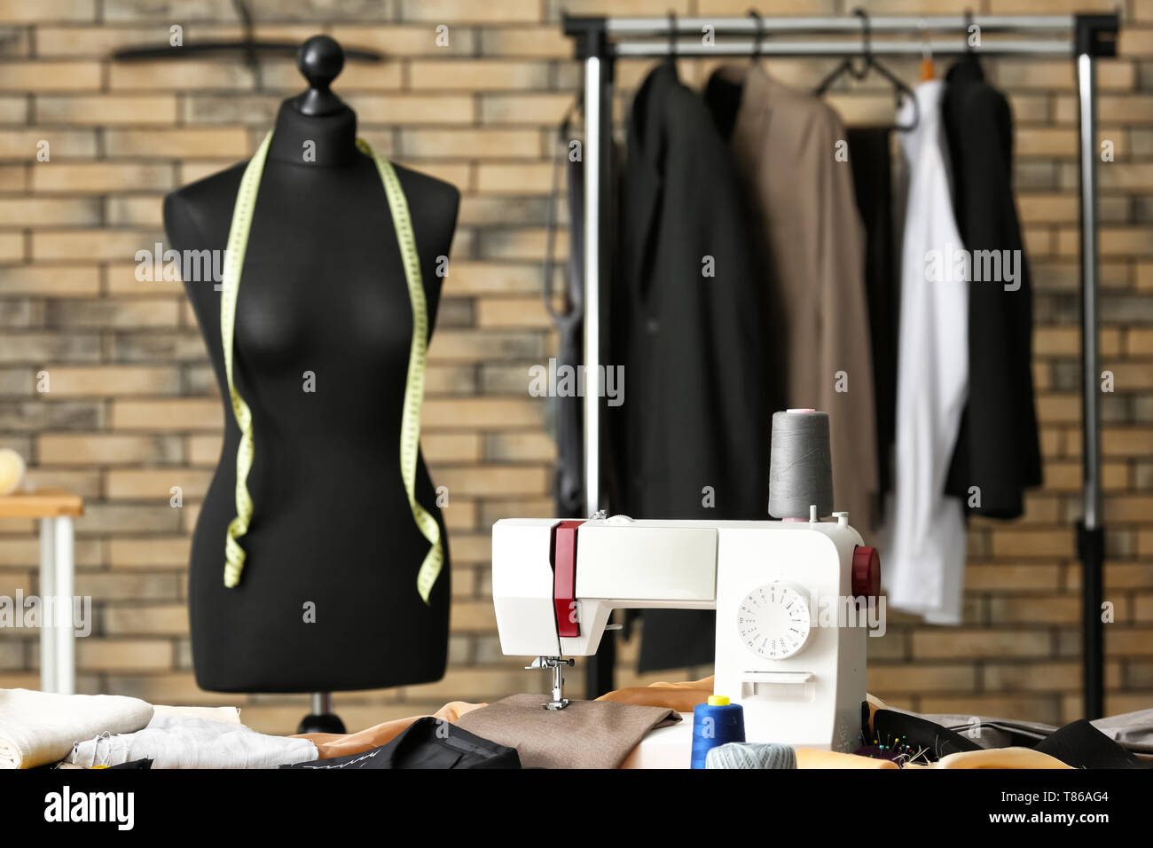 Tailor's workplace with sewing machine and mannequin in atelier Stock ...