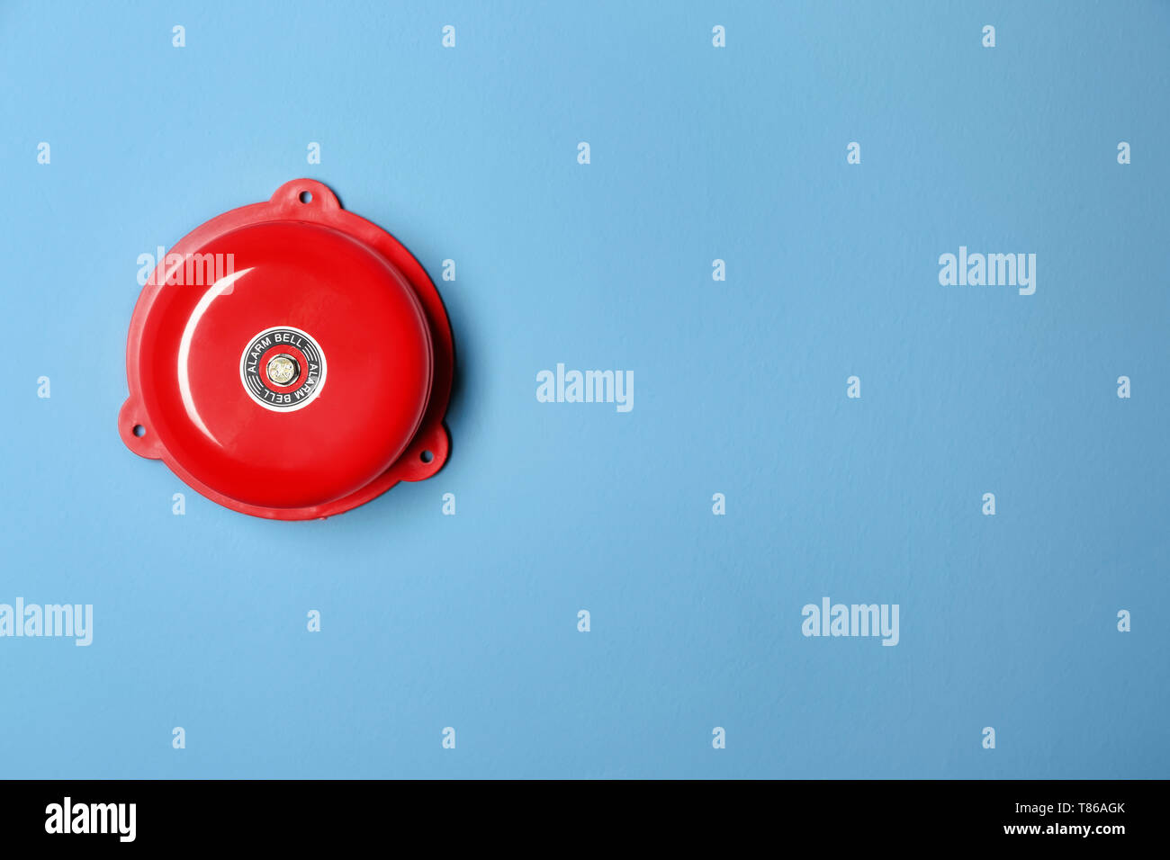 Modern alarm bell on color background Stock Photo - Alamy