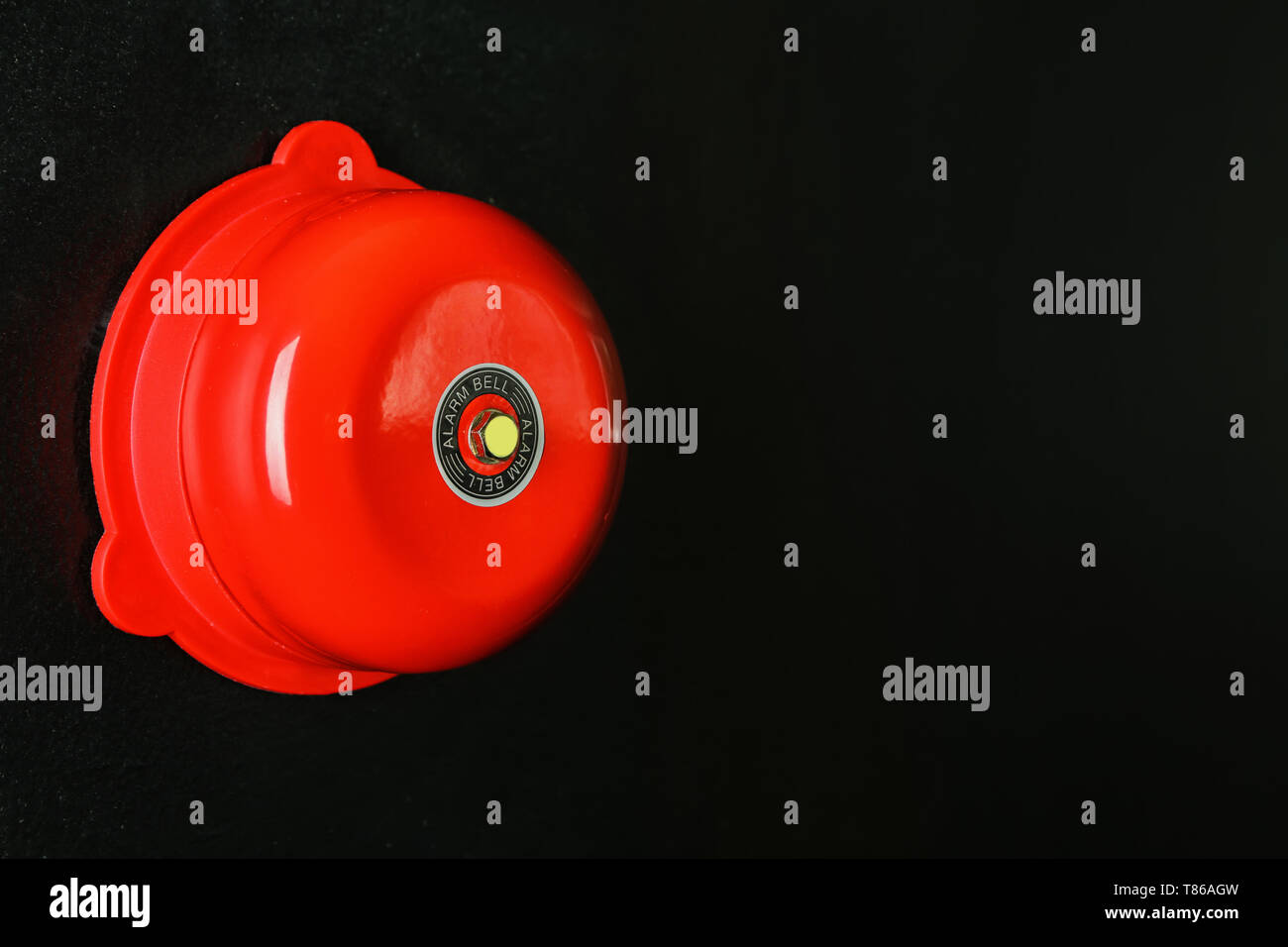 Modern alarm bell on wall indoors Stock Photo - Alamy