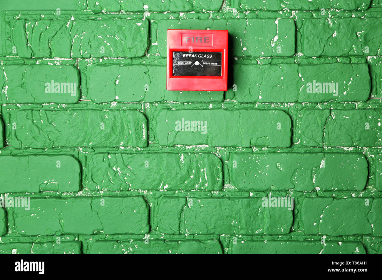 Modern fire call point on brick wall indoors Stock Photo - Alamy