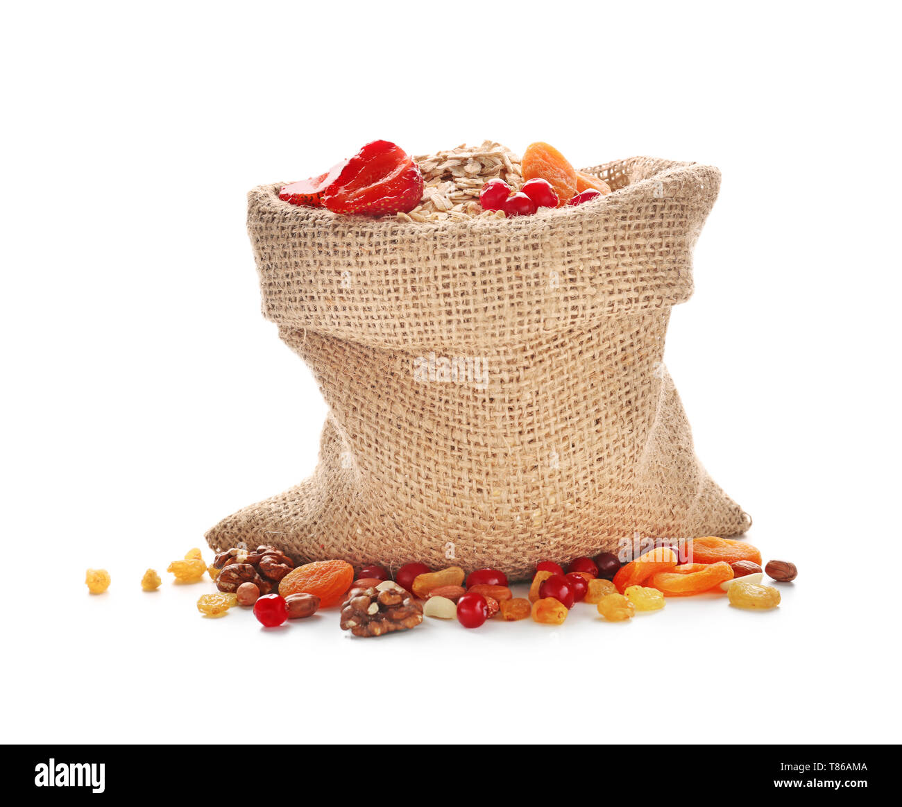 Sack with oatmeal flakes, dried fruits, berries and nuts on white ...