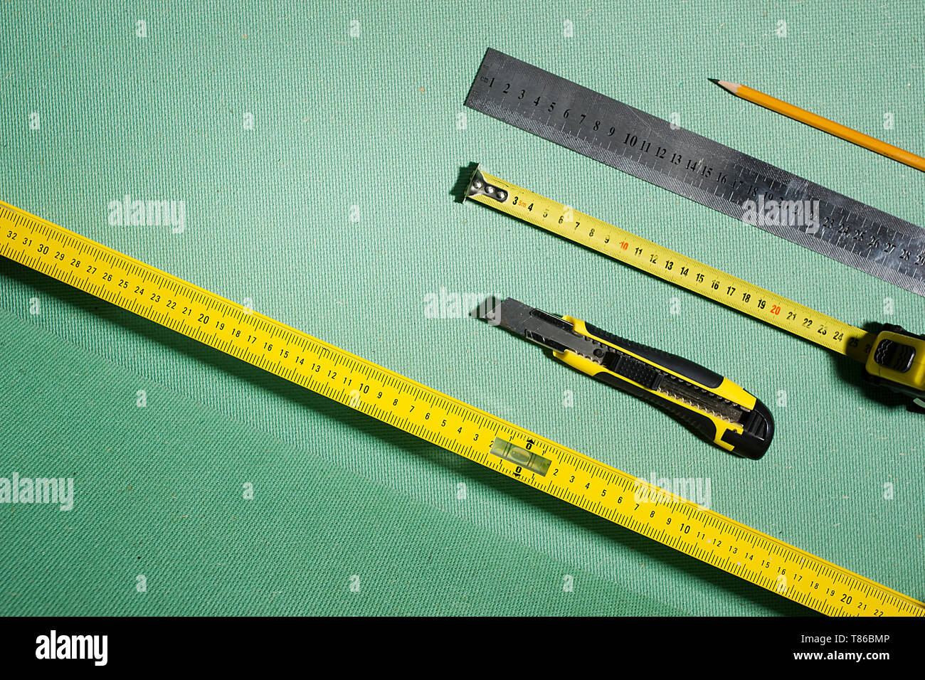 Set of construction tools on a green background Stock Photo - Alamy