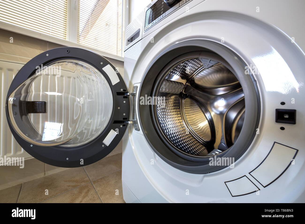 Close-up detail of modern washing machine interior with open door ...