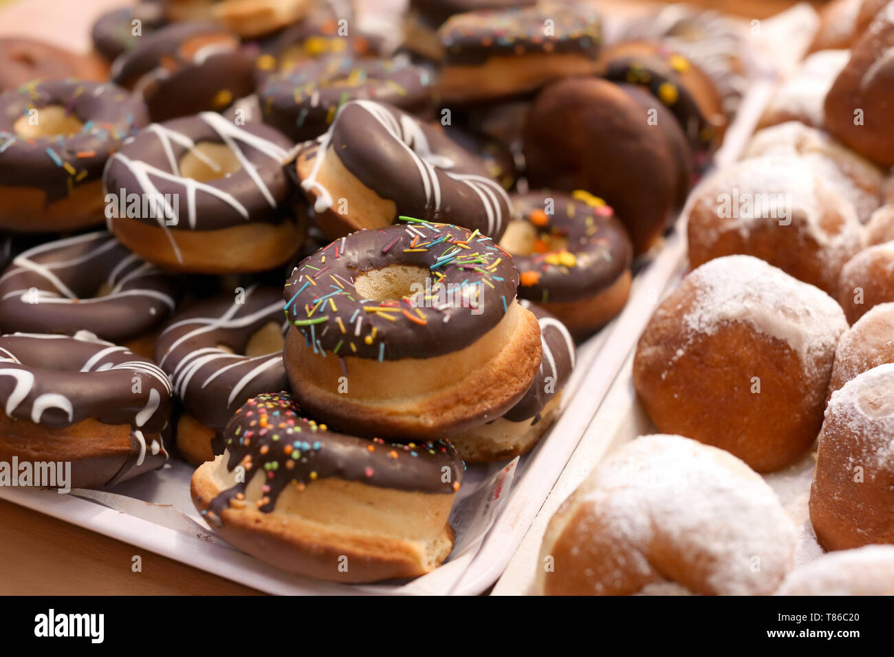 Fresh tasty donuts on display in bakery Stock Photo - Alamy