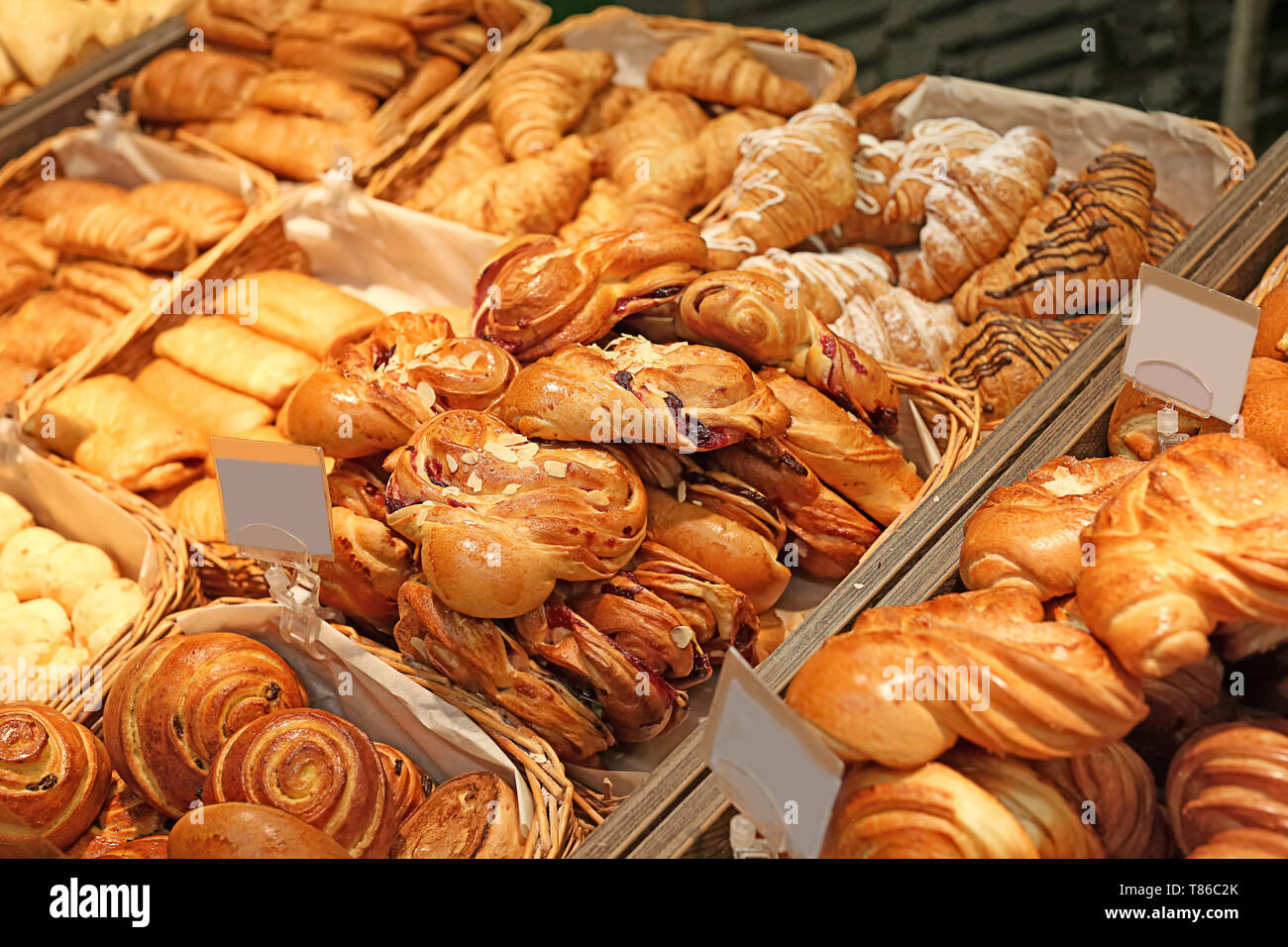 Fresh tasty pastries on display in shop Stock Photo - Alamy