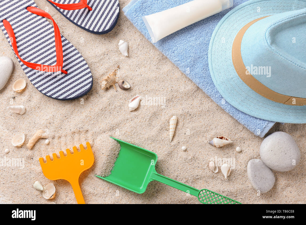 Beach accessories and sea shells on sand Stock Photo - Alamy