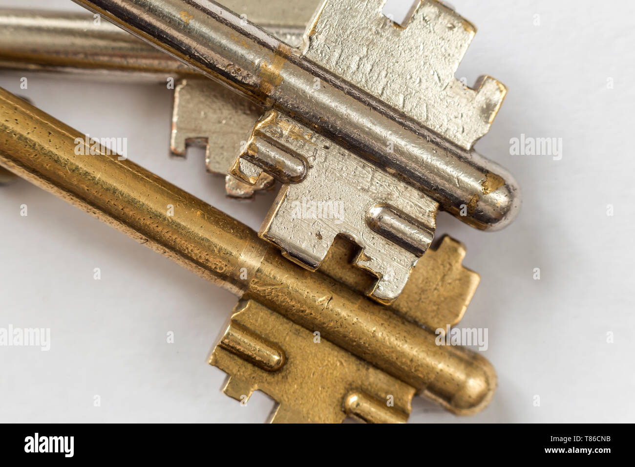 Close-up detail of old metallic keys stainless and yellow isolated on ...