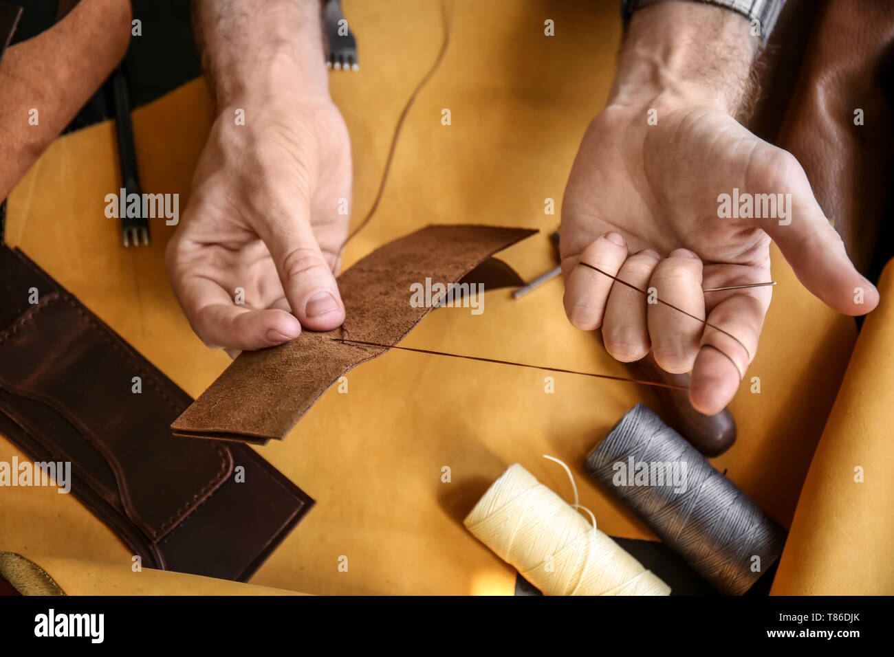 Needle and thread in leather hi-res stock photography and images - Alamy