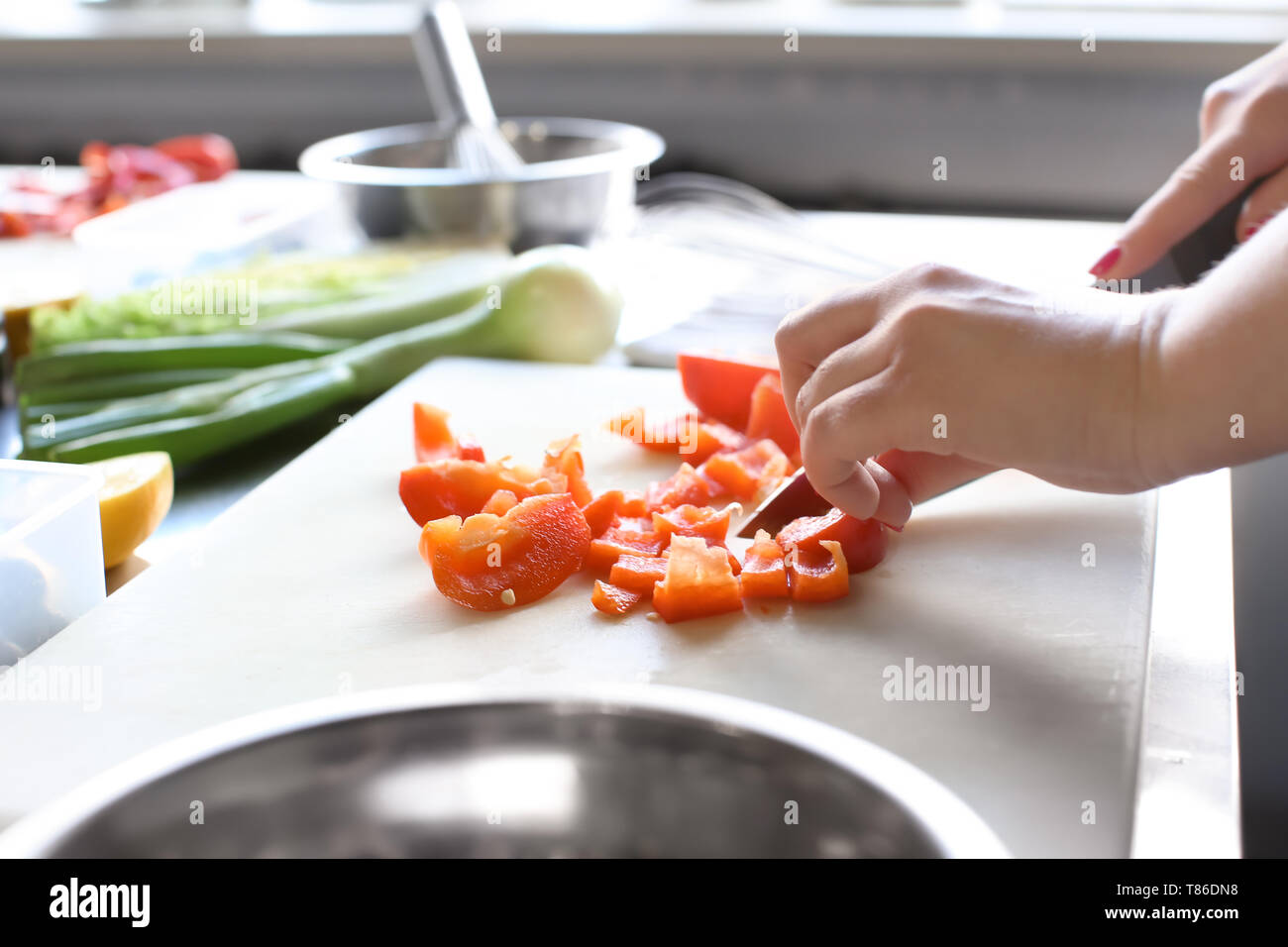 Female chef cutting vegetables in restaurant kitchen, closeup Stock ...