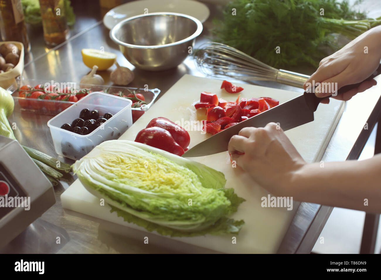 Female chef cutting vegetables in restaurant kitchen Stock Photo - Alamy