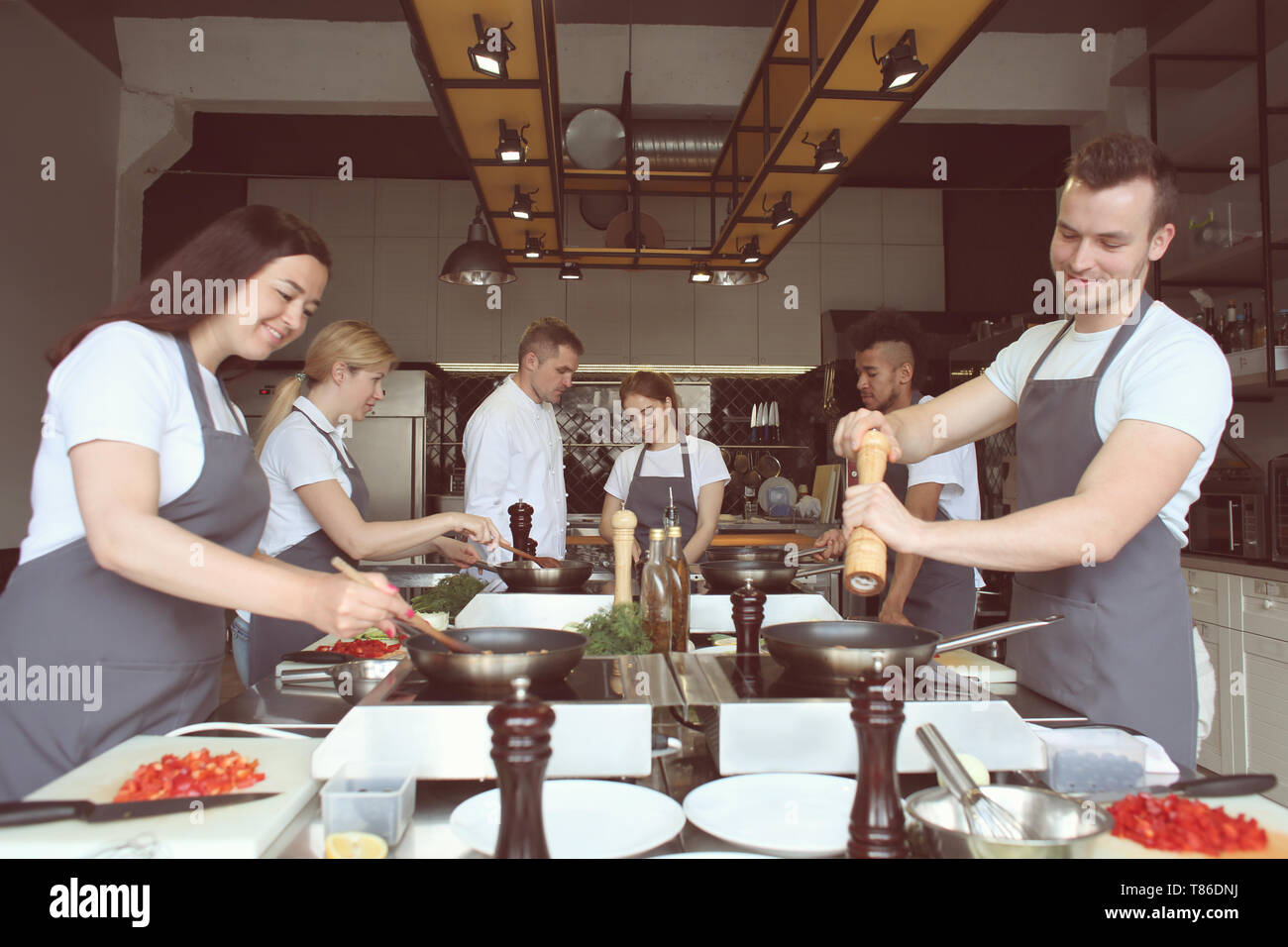 Chef and group of young people during cooking classes Stock Photo - Alamy