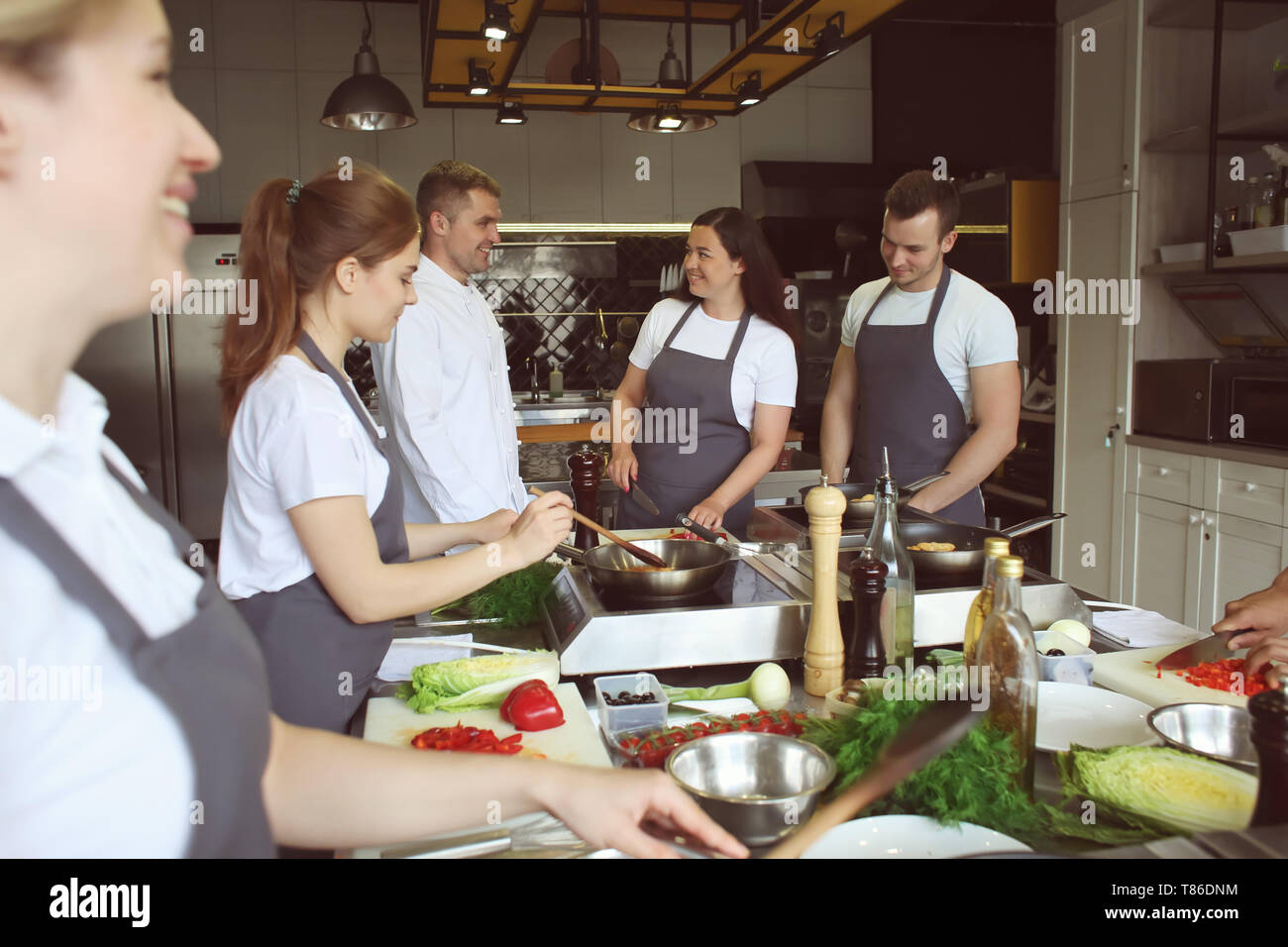 Chef and group of young people during cooking classes Stock Photo - Alamy