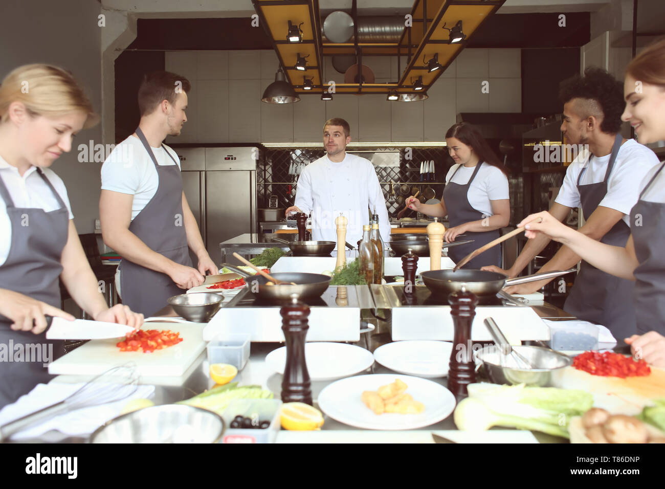 Chef and group of young people during cooking classes Stock Photo - Alamy