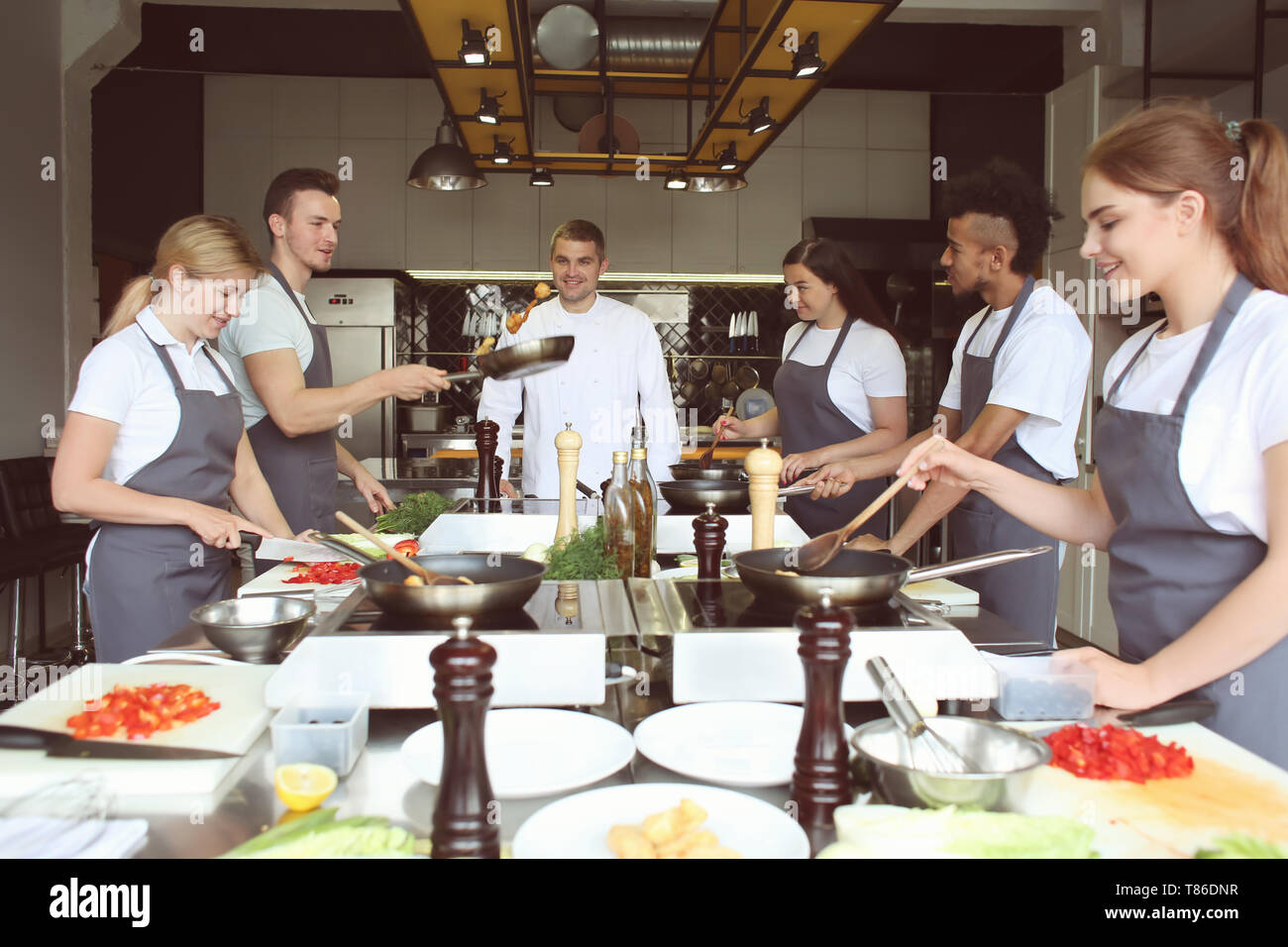 Chef and group of young people during cooking classes Stock Photo - Alamy