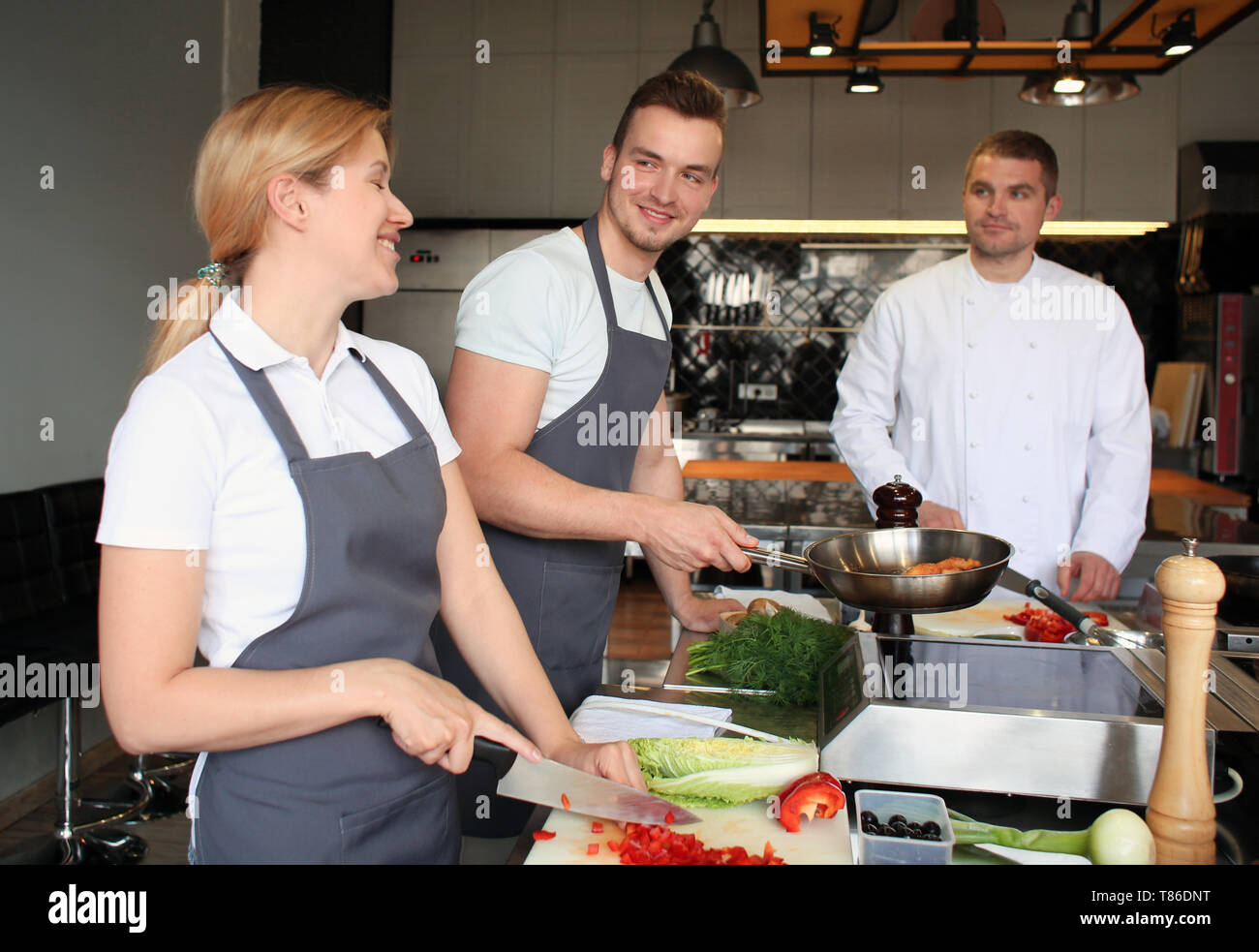 Chef and group of young people during cooking classes Stock Photo - Alamy