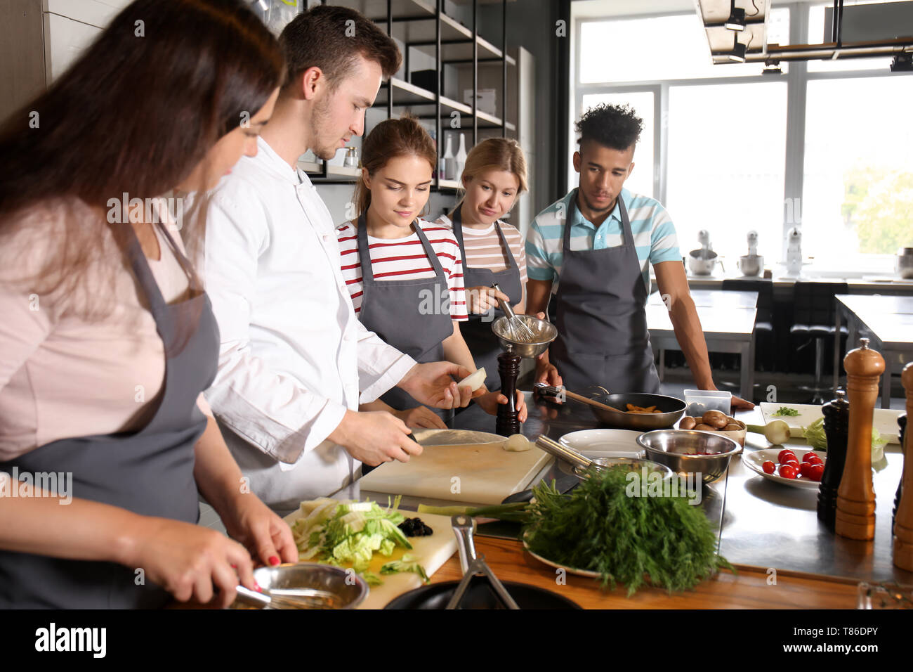 Chef and group of young people during cooking classes Stock Photo - Alamy