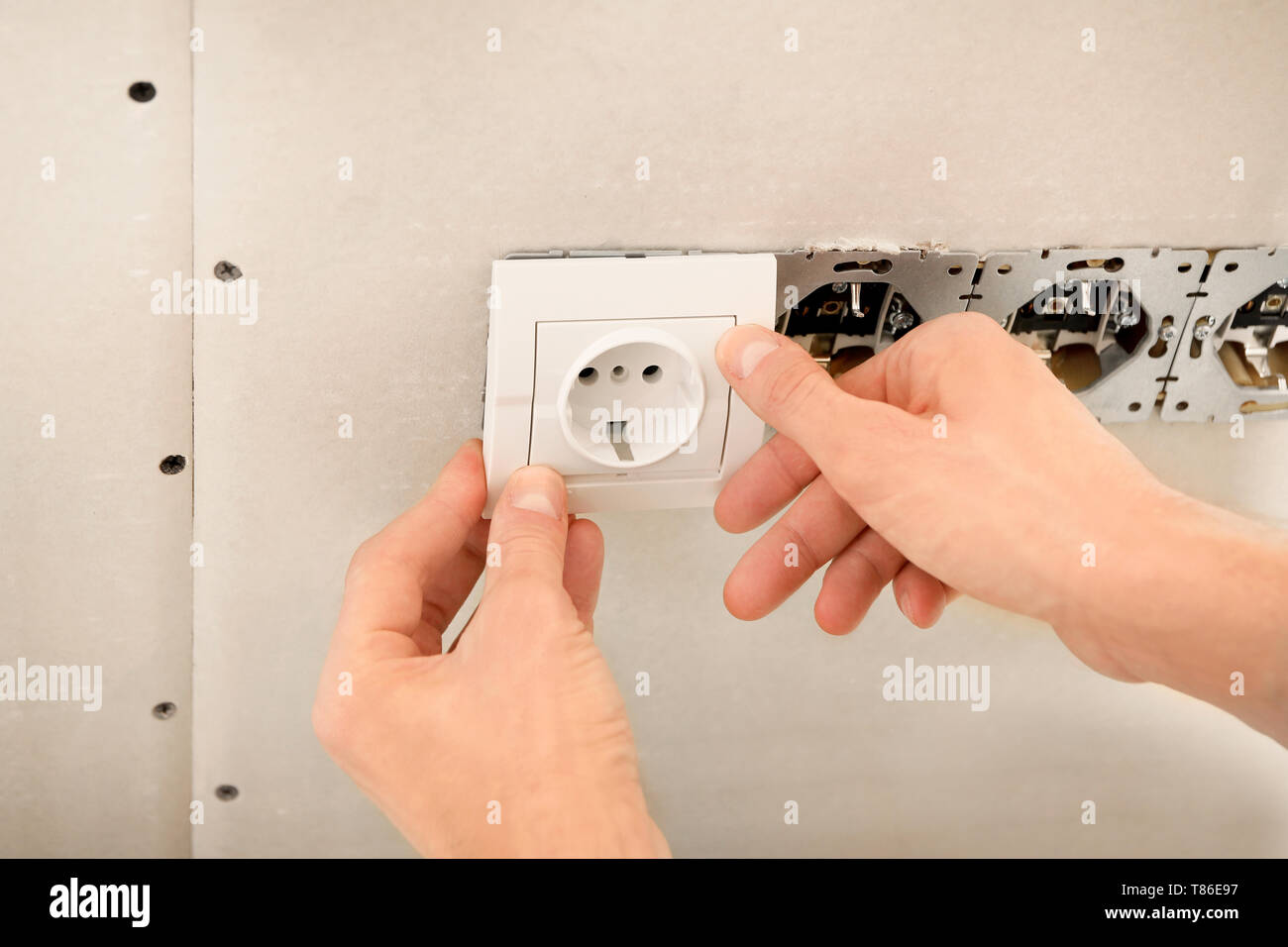 Male electrician repairing socket in flat, closeup Stock Photo - Alamy