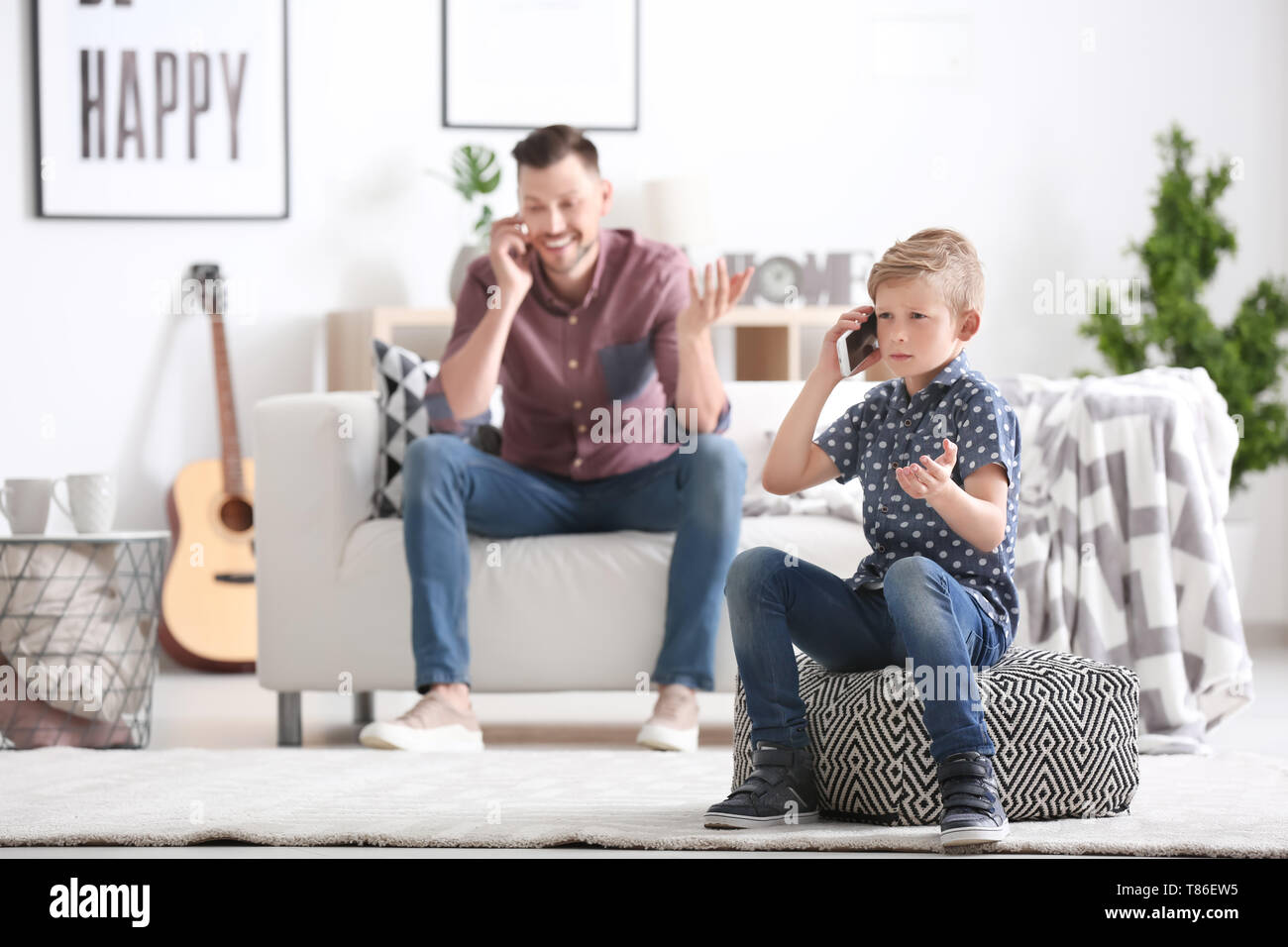 Dad and his little son talking on mobile phones at home Stock Photo - Alamy