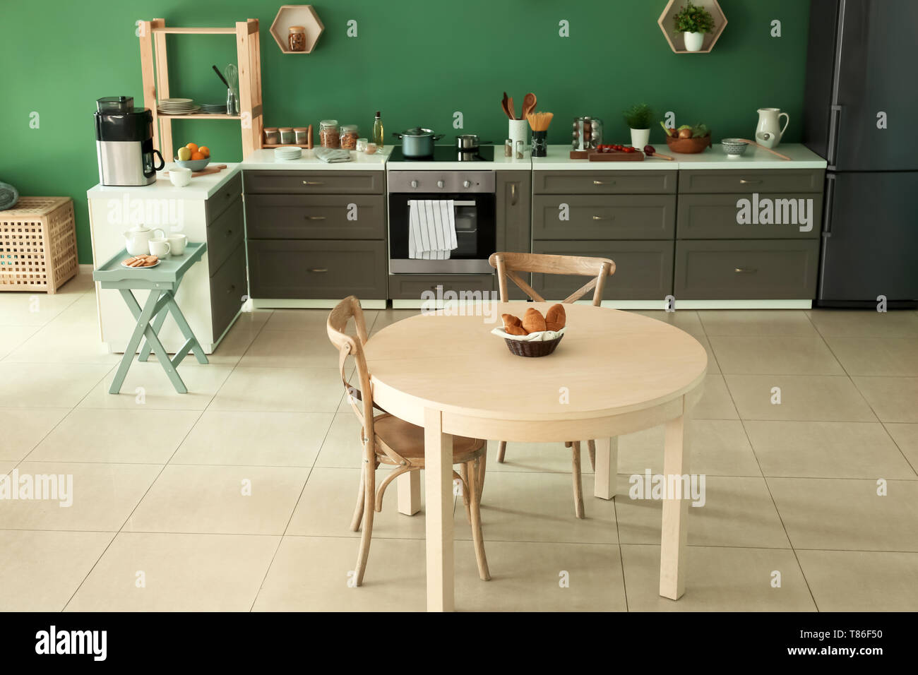 Modern interior of kitchen with wooden table Stock Photo - Alamy