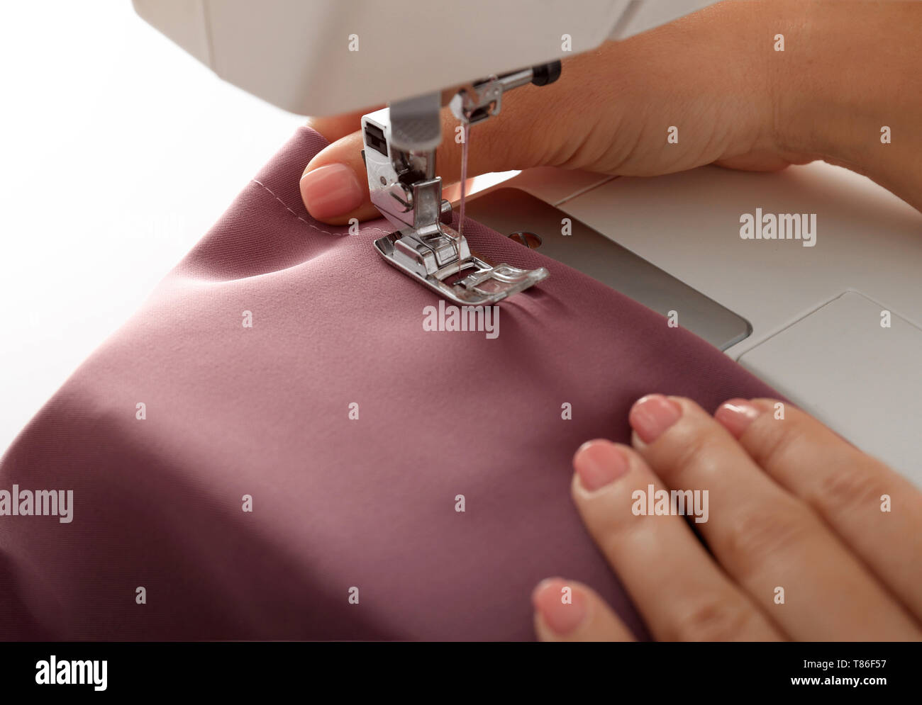 Female tailor using sewing machine, closeup Stock Photo - Alamy