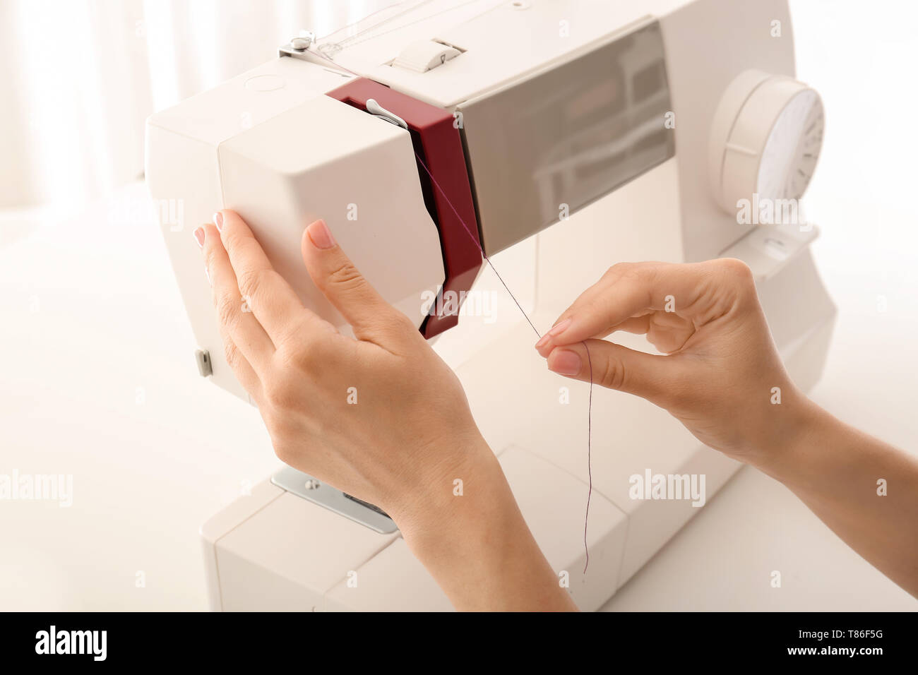 Female tailor threading sewing machine Stock Photo - Alamy