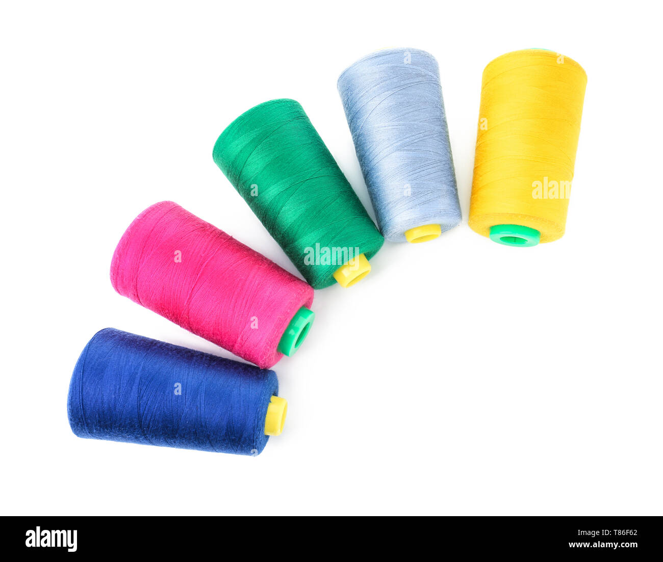 Color sewing threads on white background Stock Photo - Alamy