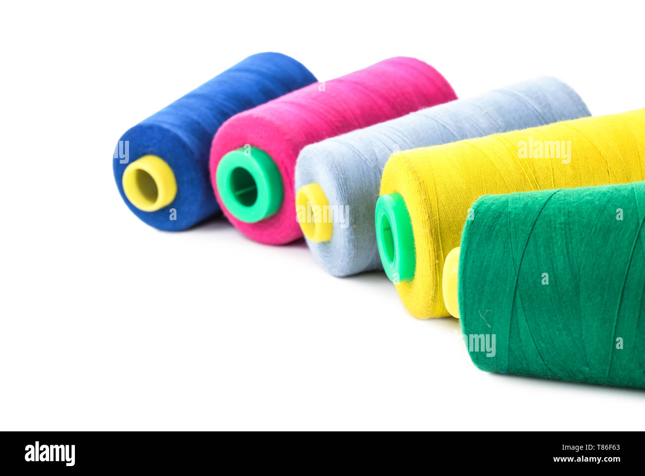 Color sewing threads on white background Stock Photo - Alamy