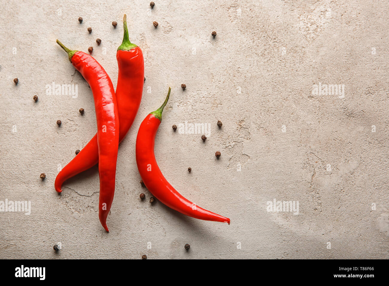 Fresh chili peppers on light background Stock Photo - Alamy