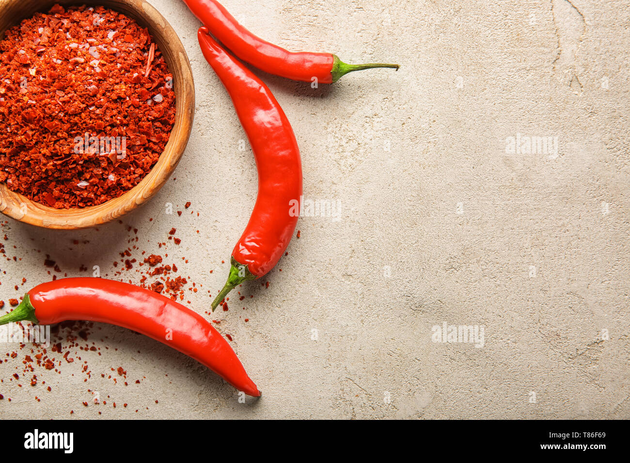 Fresh and dry granulated chili pepper on table Stock Photo - Alamy