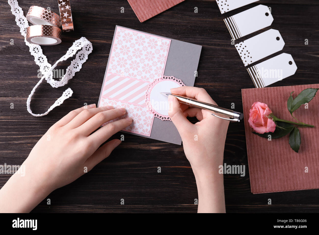 Woman making scrapbook on wooden background Stock Photo - Alamy