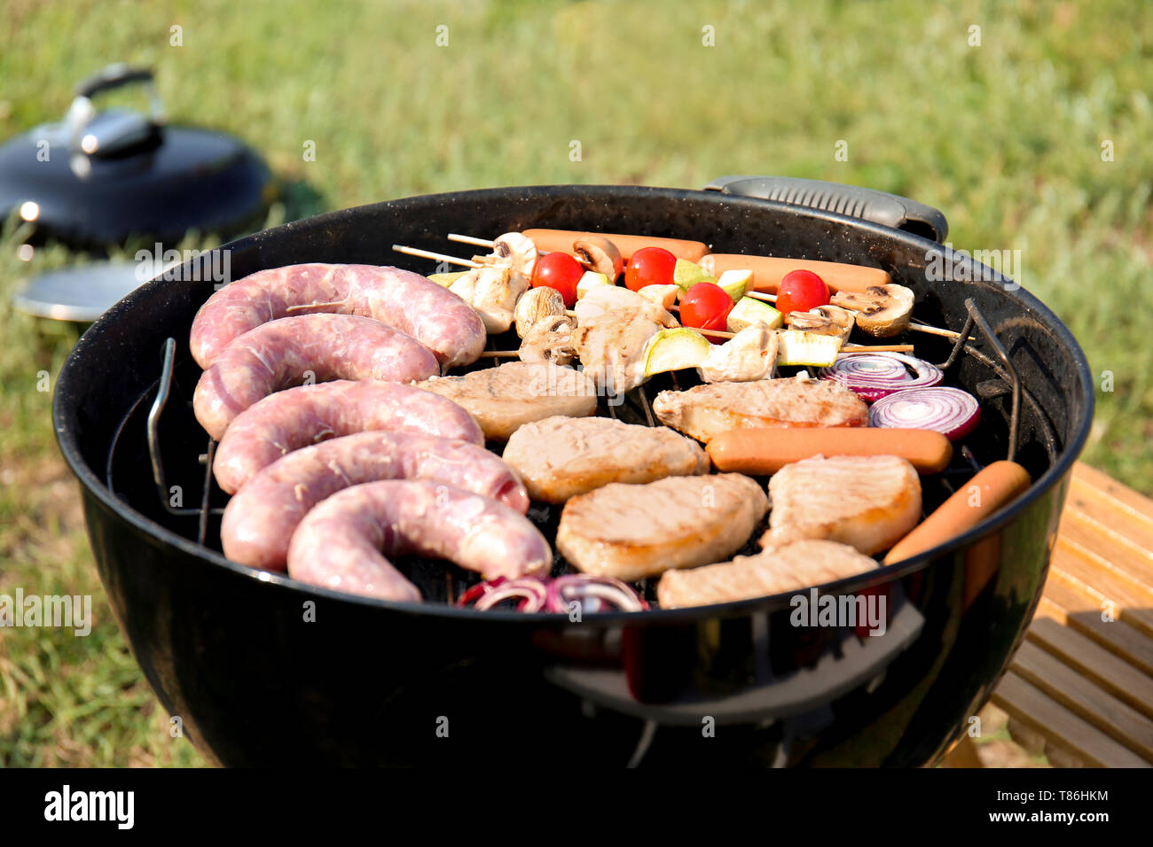 Meat and vegetables on modern grill outdoors Stock Photo - Alamy