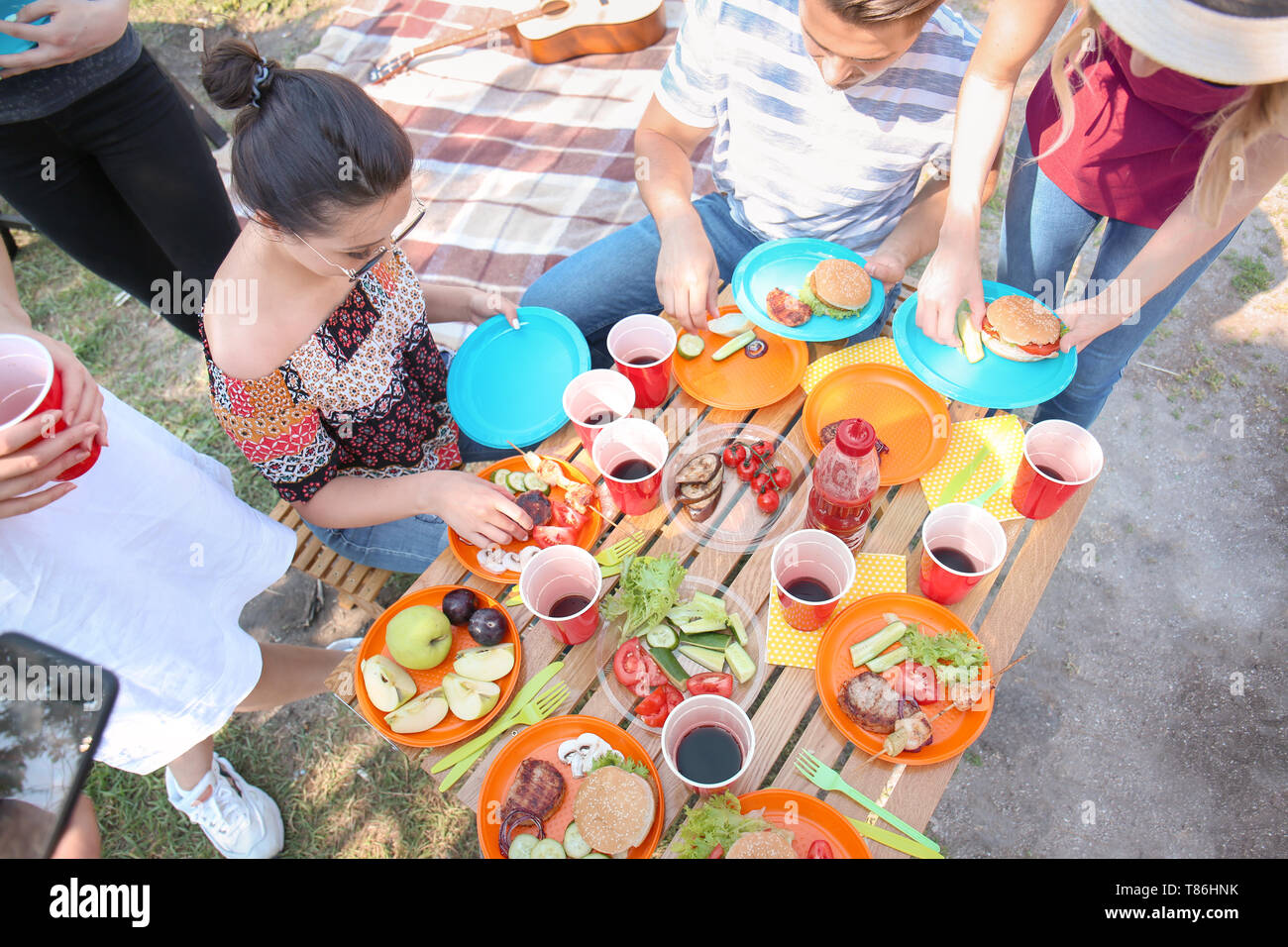 Young people having barbecue party outdoors Stock Photo - Alamy
