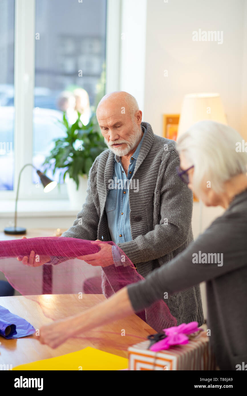 Good looking aged people packing gifts together Stock Photo - Alamy