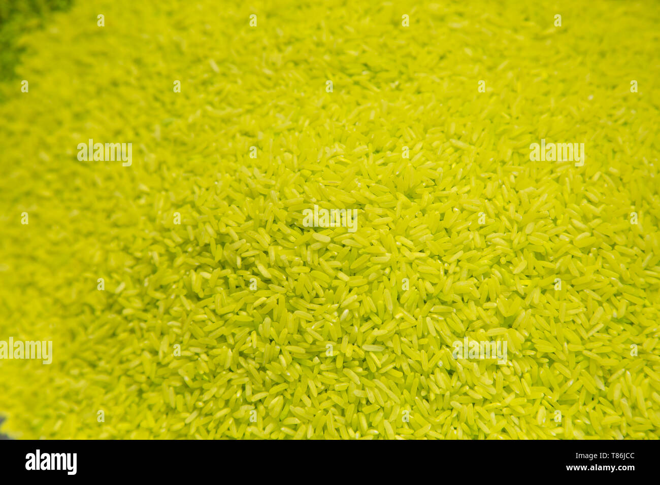 Uncooked raw yellow rice grains background texture Stock Photo - Alamy