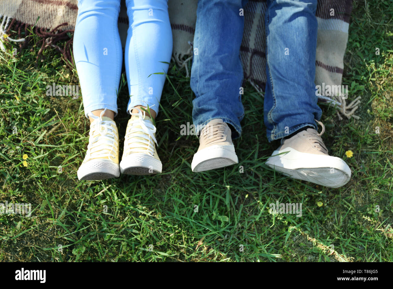 Legs couple lying on grass hi-res stock photography and images - Alamy