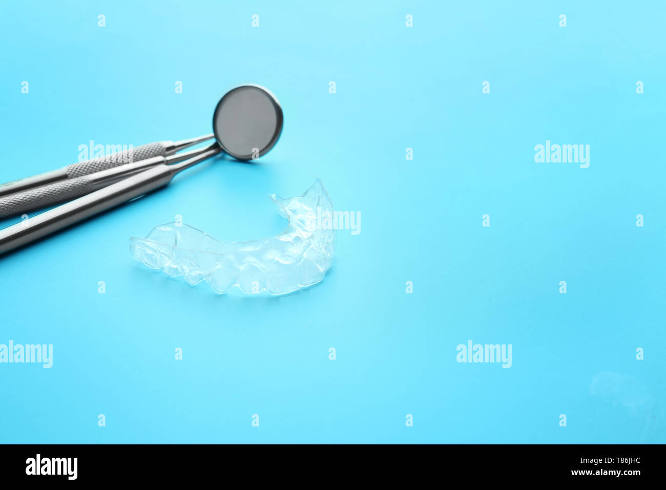 Dental instruments and occlusal splint on color background Stock Photo ...