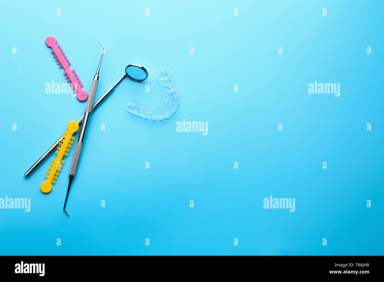 Dental instruments and occlusal splint on color background Stock Photo ...