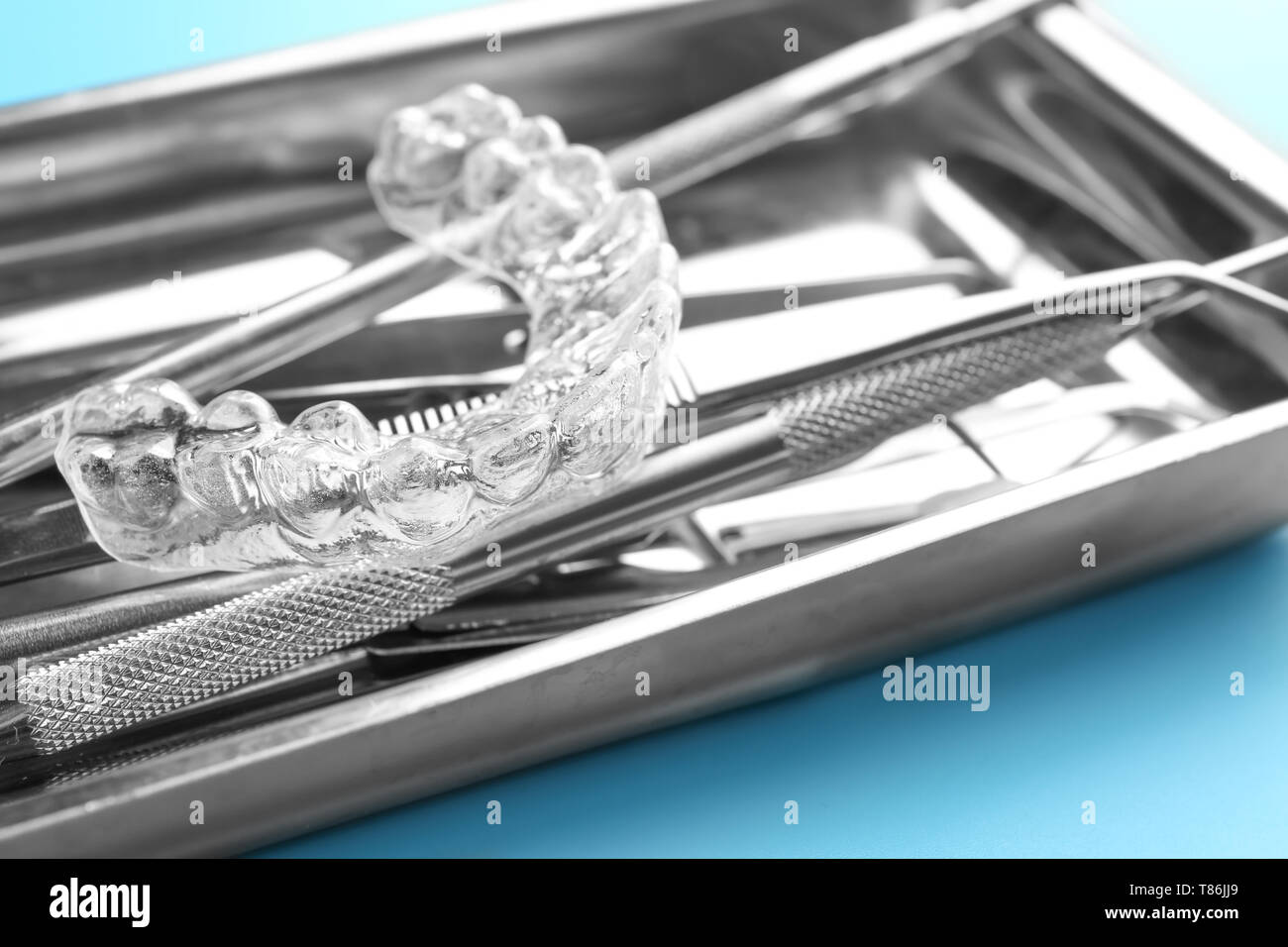 Tray with dental instruments and occlusal splint on color background ...