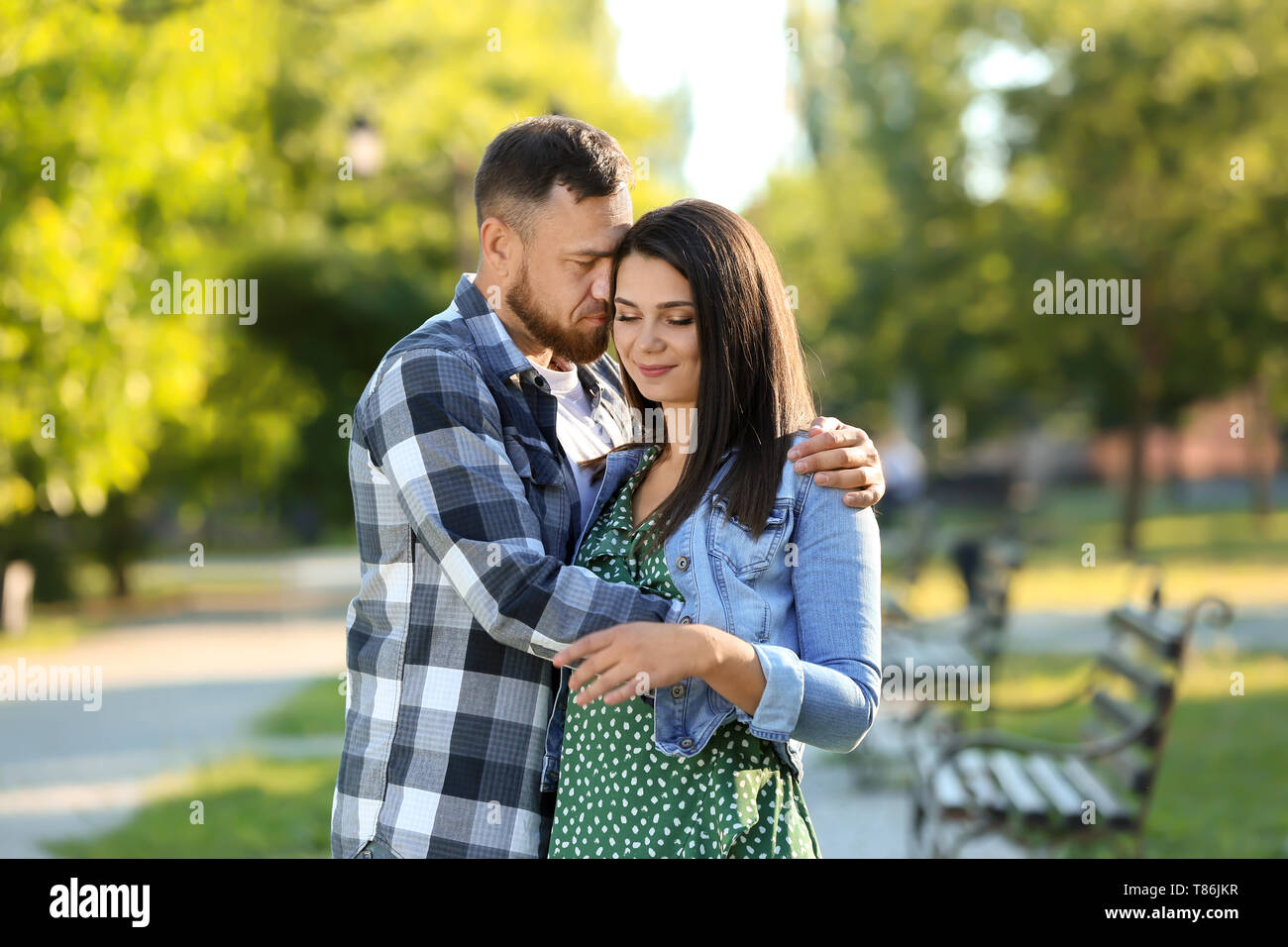 Happy couple in park on spring day Stock Photo - Alamy