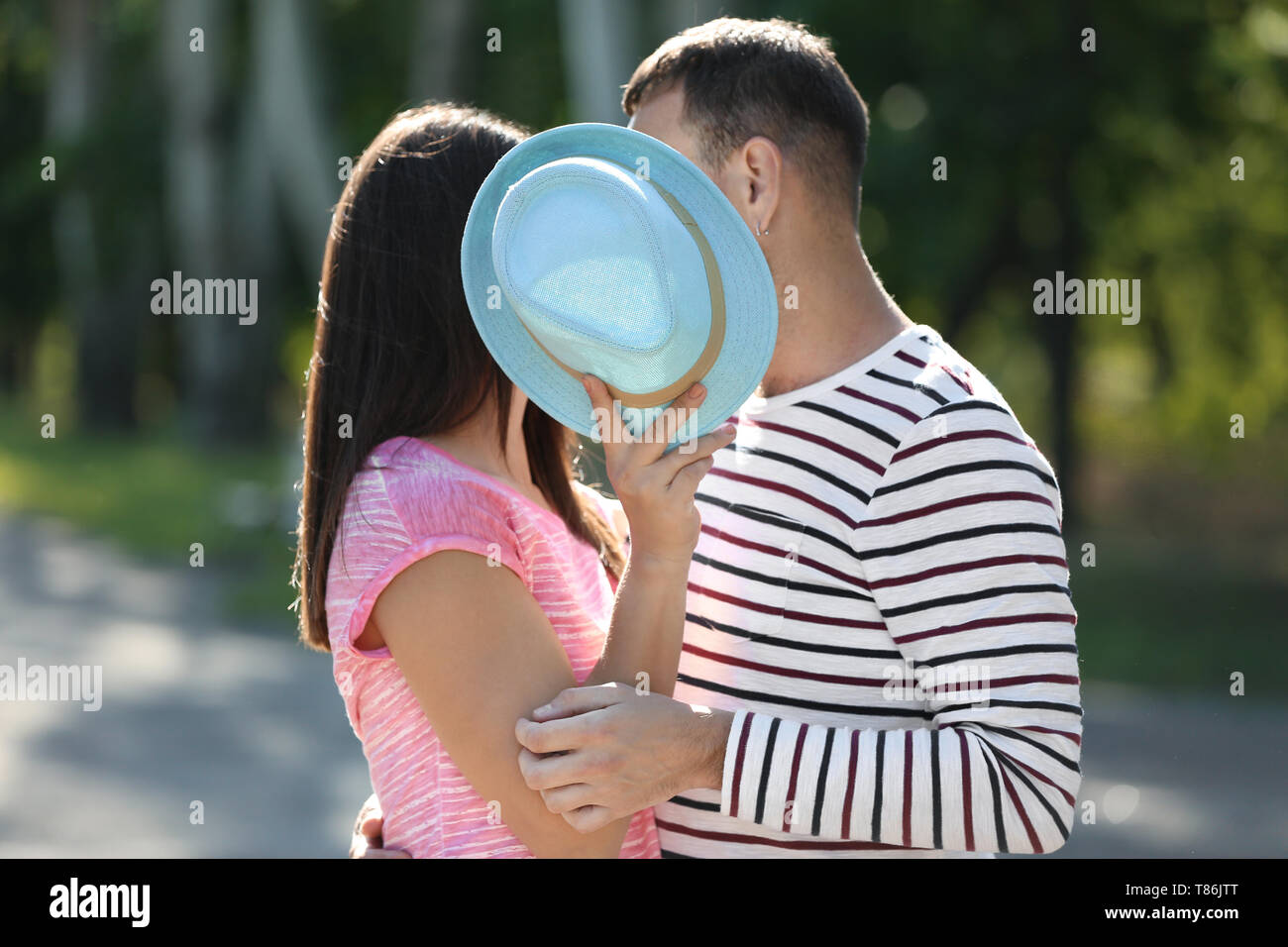 Spring couple walking kissing hi-res stock photography and images - Alamy